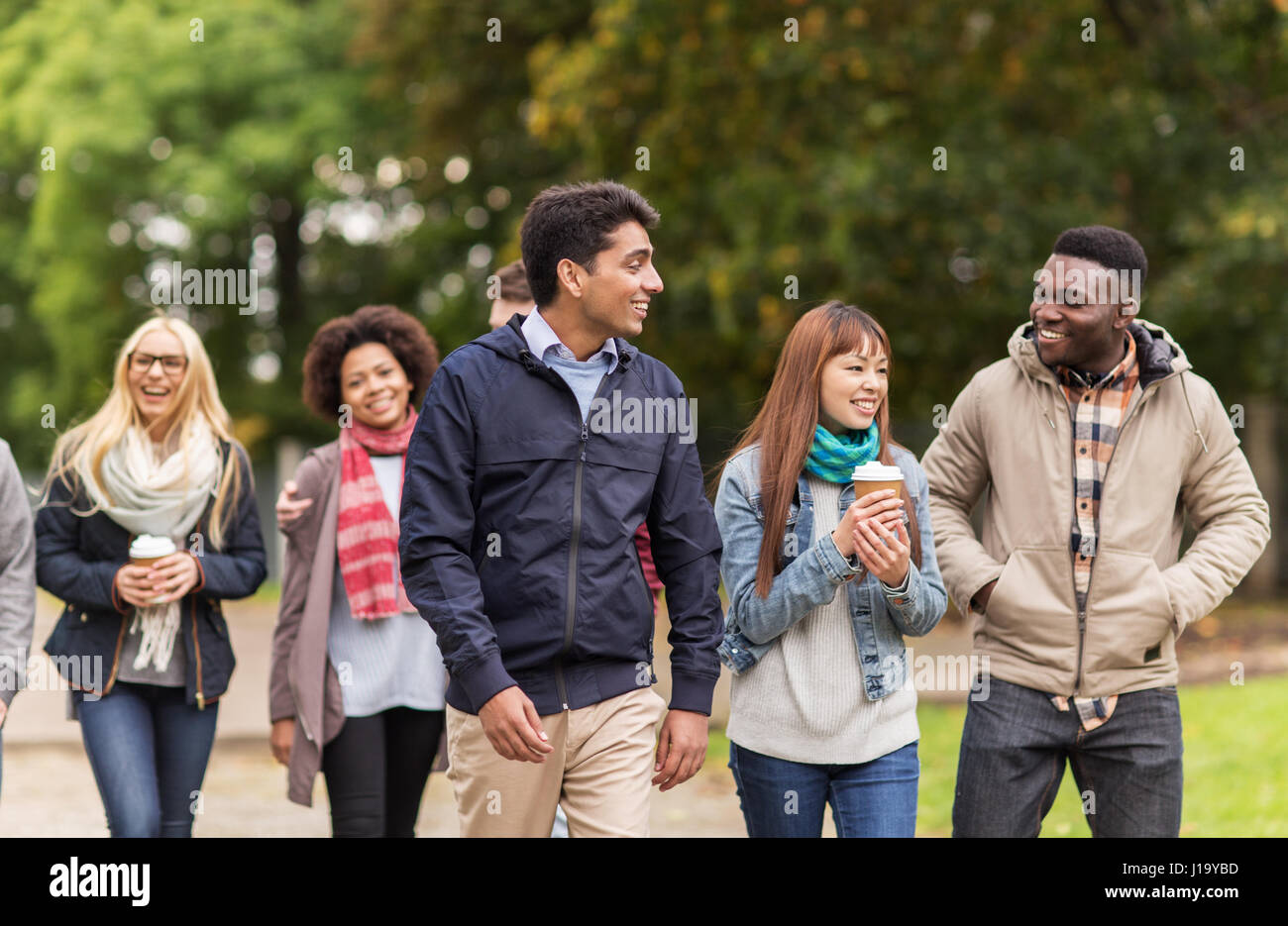 happy friends walking along autumn park Stock Photo - Alamy
