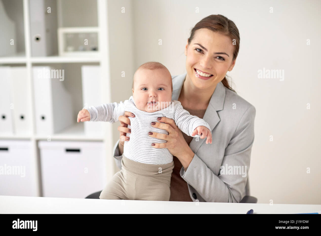 happy businesswoman with baby at office Stock Photo - Alamy