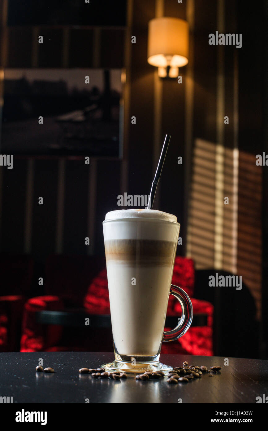 Fancy latte coffee in glass jar on the black table Stock Photo - Alamy