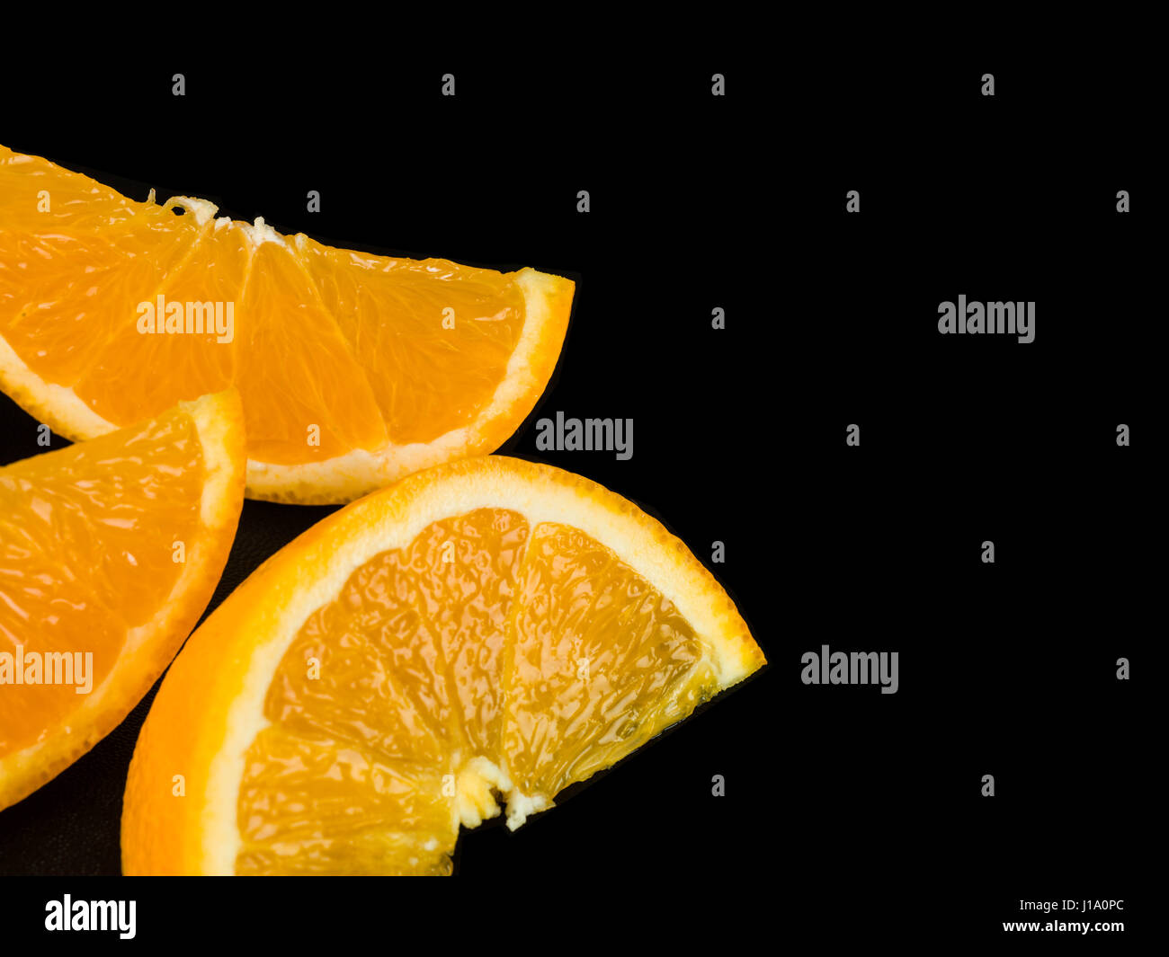 Juicy Fresh Fruit Orange Segments Against a Black Background Stock ...