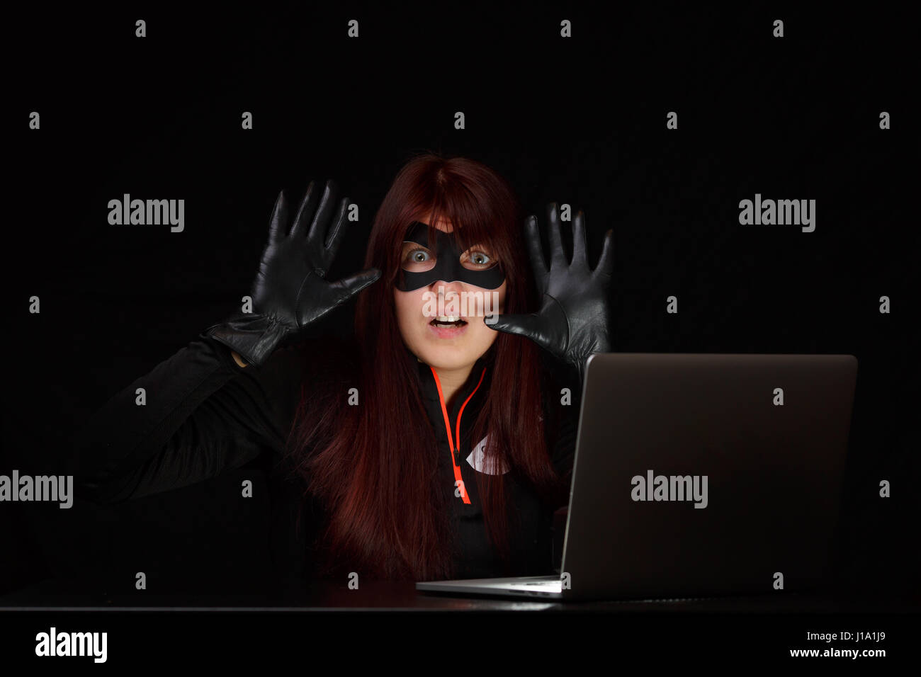 Brunette spy with raised hands Stock Photo - Alamy