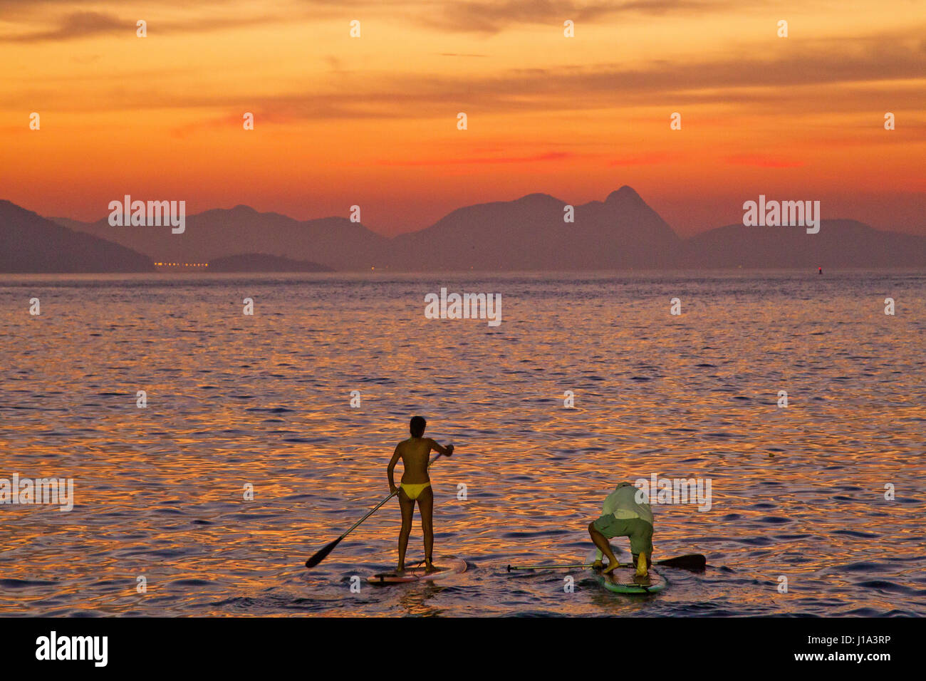 People doing stand up trainning early morning at Praia Vermelha, Urca ...