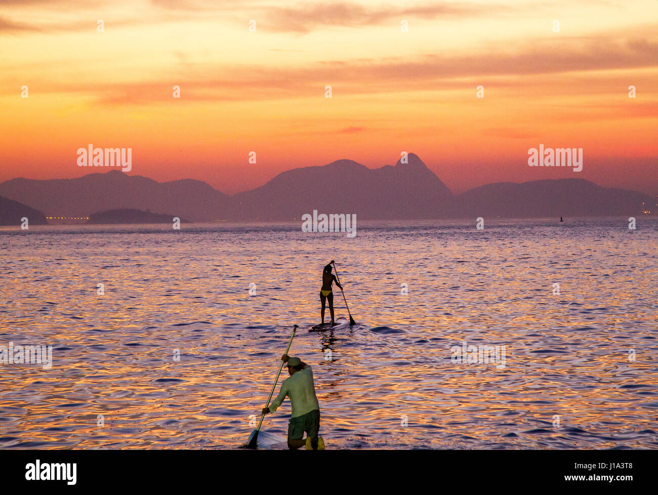 People doing stand up trainning early morning at Praia Vermelha, Urca ...