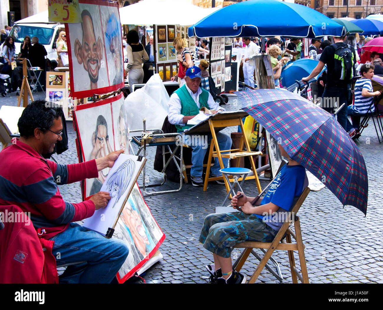 Florence, Italy, 28 April, 2011. Street artist painting a caricature of ...