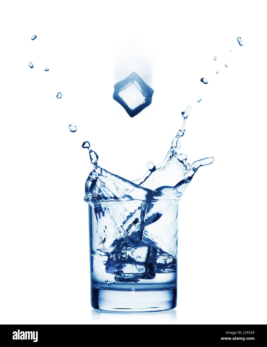 Splash of water in a wide glass with a flying ice cube isolated on a ...