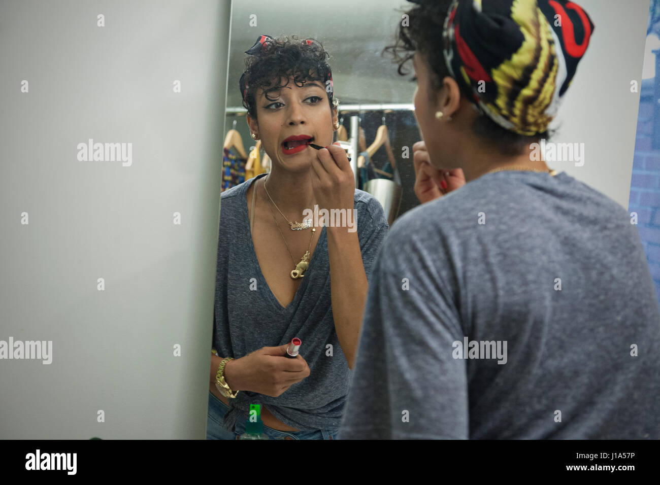 Young woman preparing to go out Stock Photo - Alamy