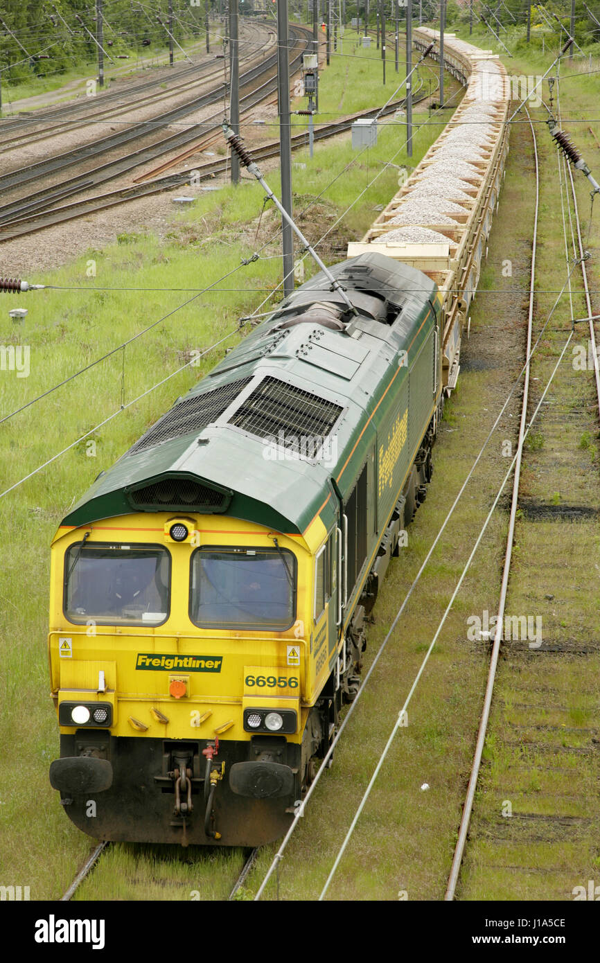 Class 66 diesel locomotive 66956 with train of loaded ballast wagons at ...