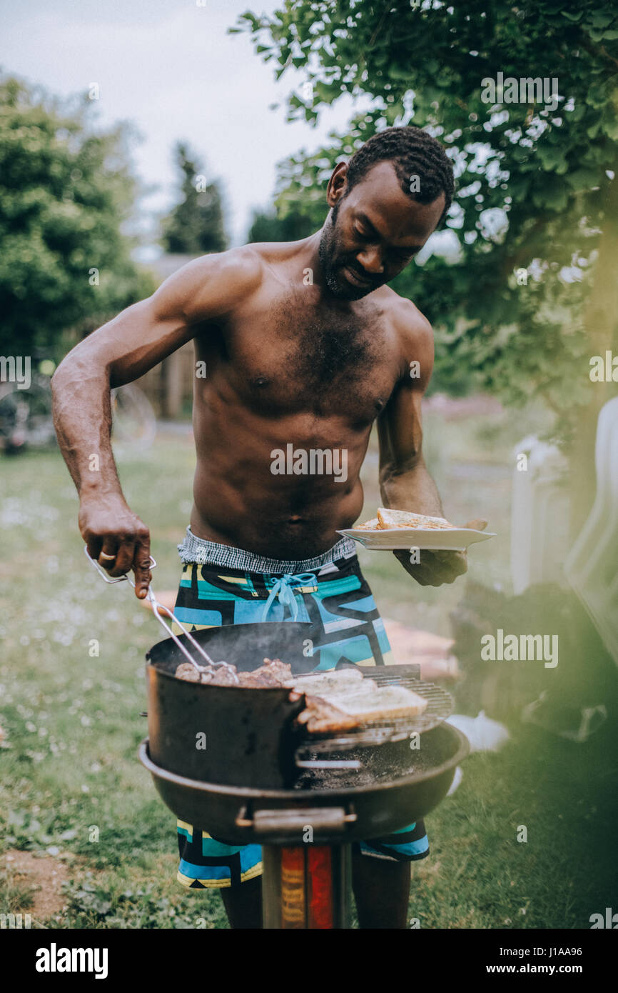 Black man preparing a barbeque Stock Photo - Alamy