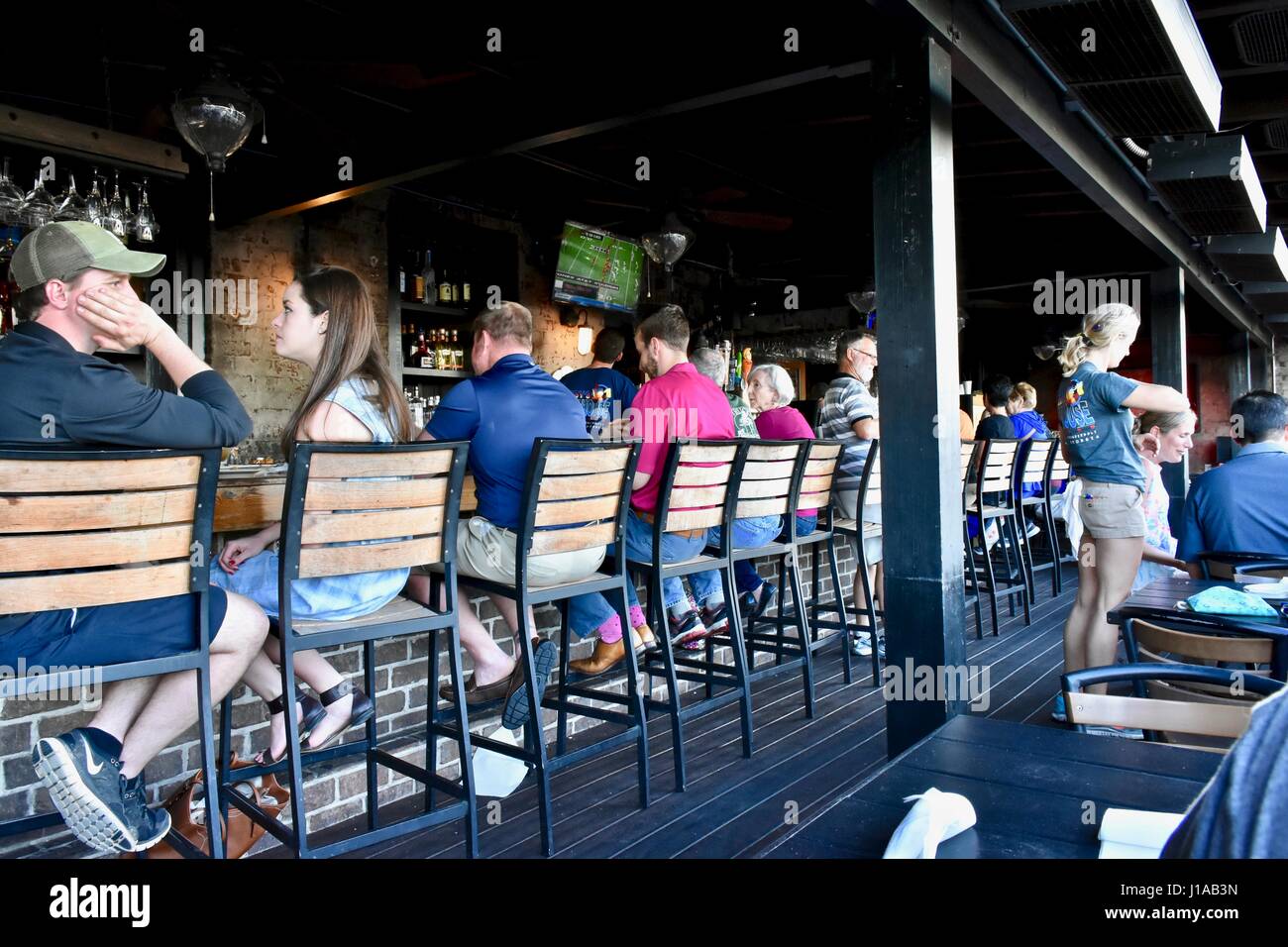 Customers sitting at restaurant bar Stock Photo - Alamy