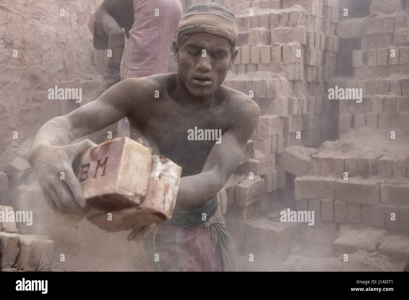 Dhaka, Bangladesh. 19th Apr, 2017. A migrant laborer works amid the ...