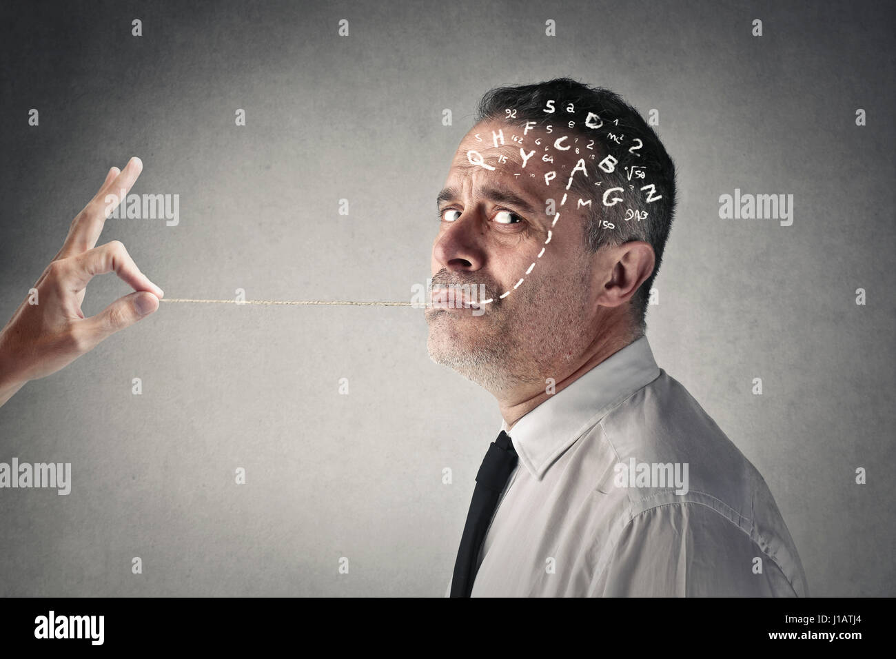 Hand pulling out words from businessman Stock Photo - Alamy