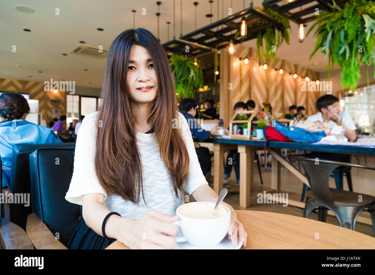 Coffee library portrait of asian university woman drinking latte art ...