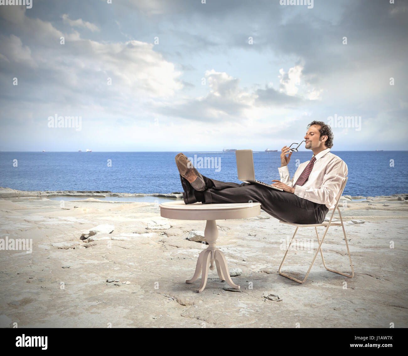 Businessman working on the beach Stock Photo - Alamy