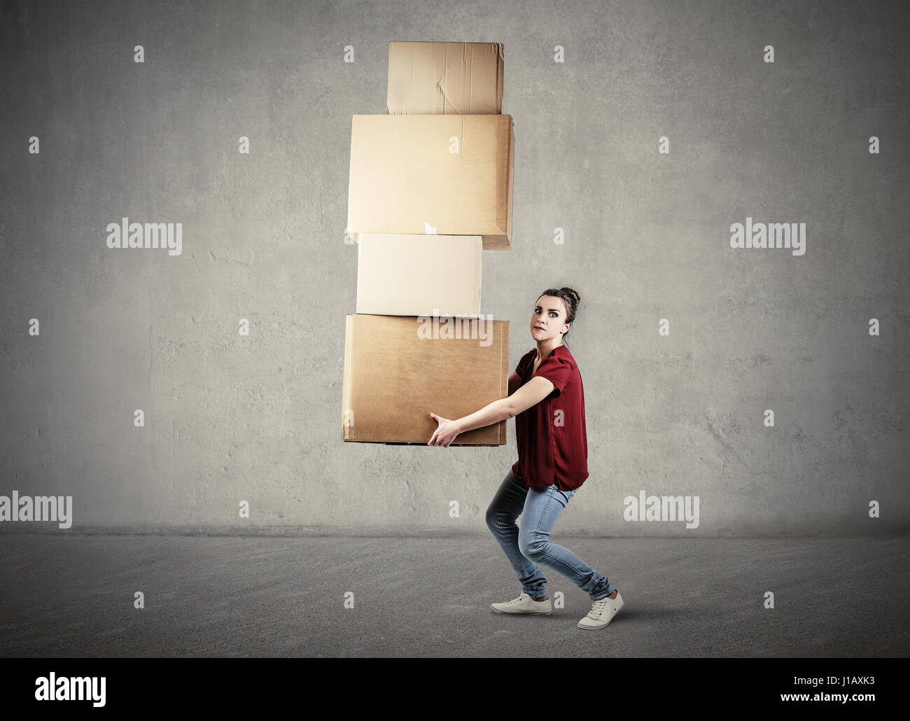 Woman carrying heavy boxes Stock Photo - Alamy