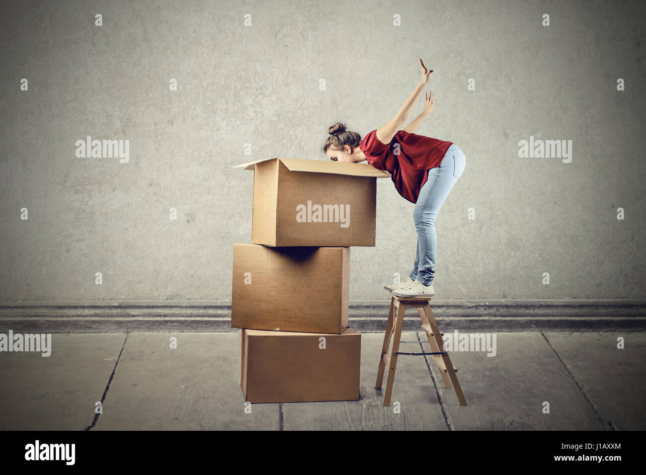 Woman looking into boxes Stock Photo - Alamy