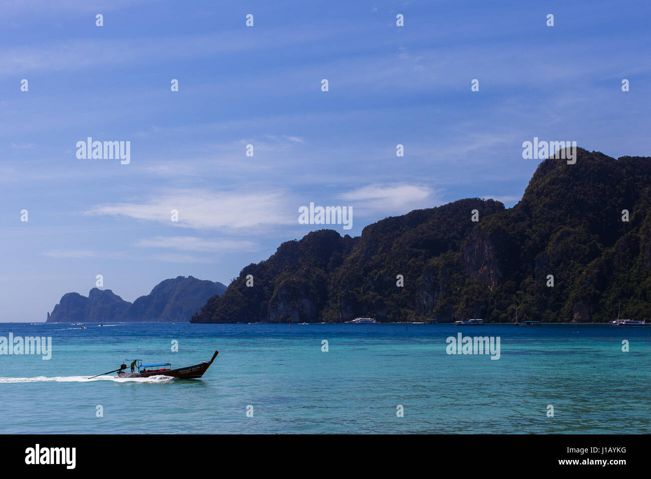 Sea coast with floating boat Stock Photo - Alamy