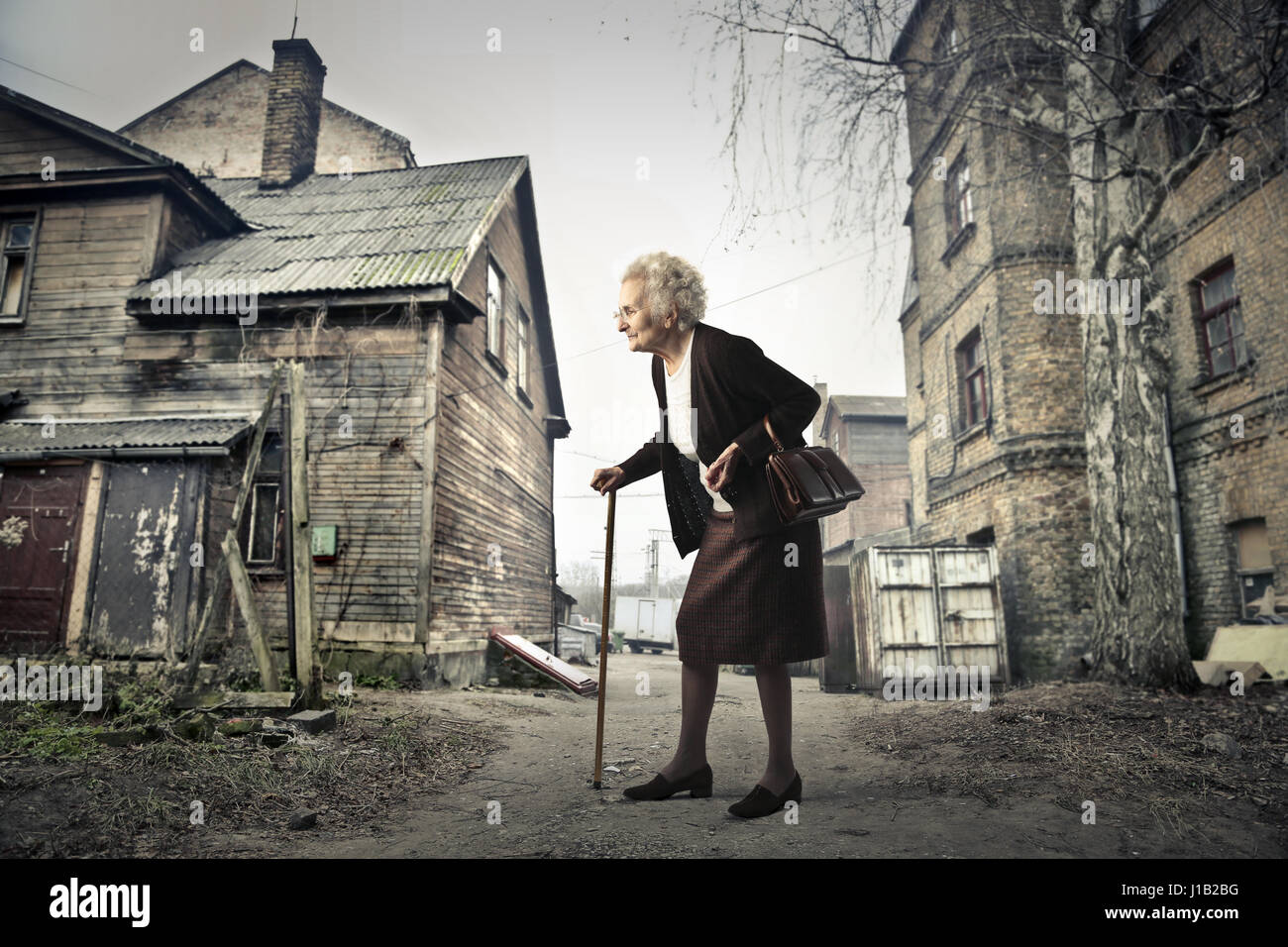 Old lady walking with stick in empty village Stock Photo - Alamy
