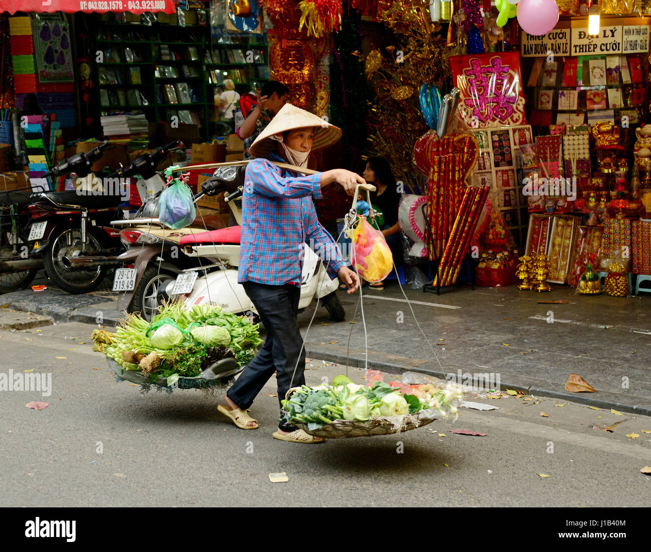 Street traders and hawkers selling hats, fruit, vegetables, cleaning ...