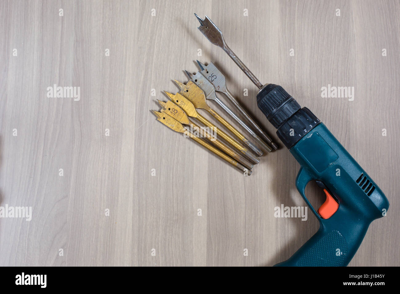 Different tools on a wooden background. drill, Wood drill, concrete ...
