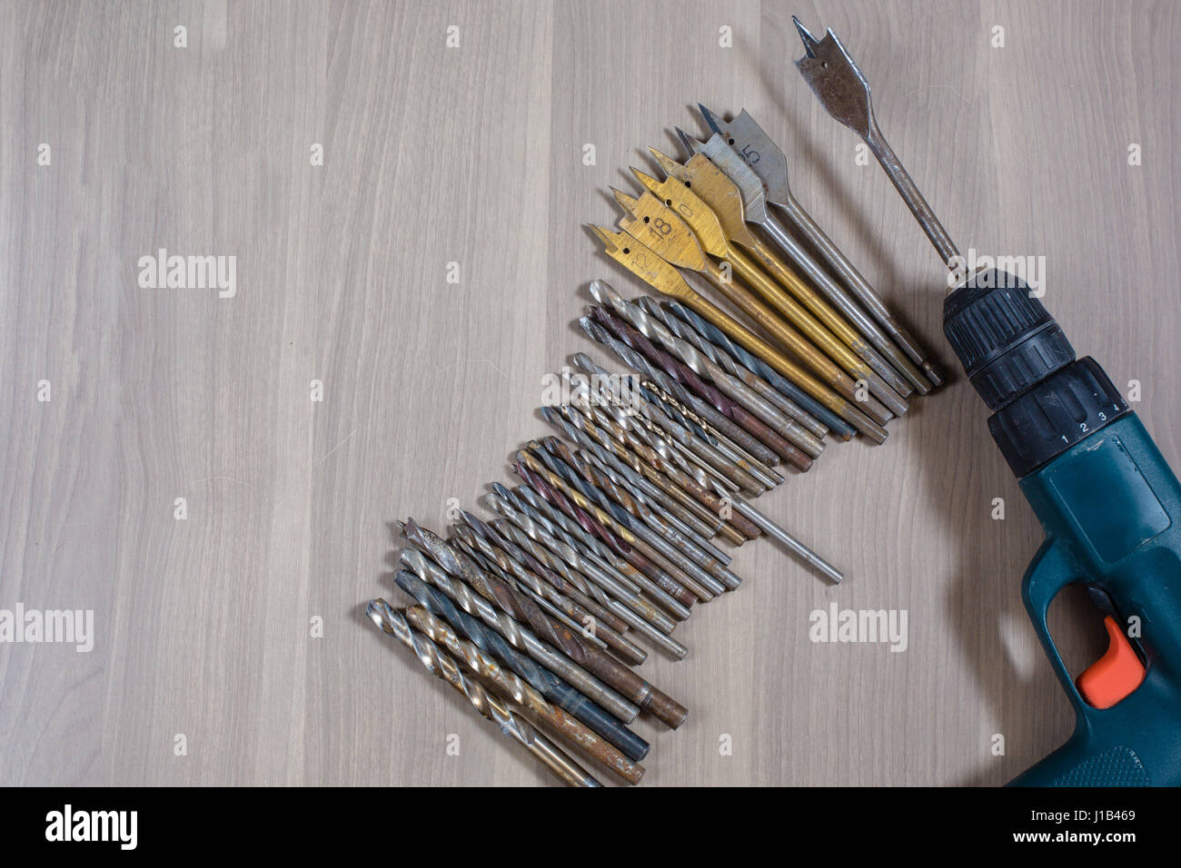 Different tools on a wooden background. drill, Wood drill, concrete ...