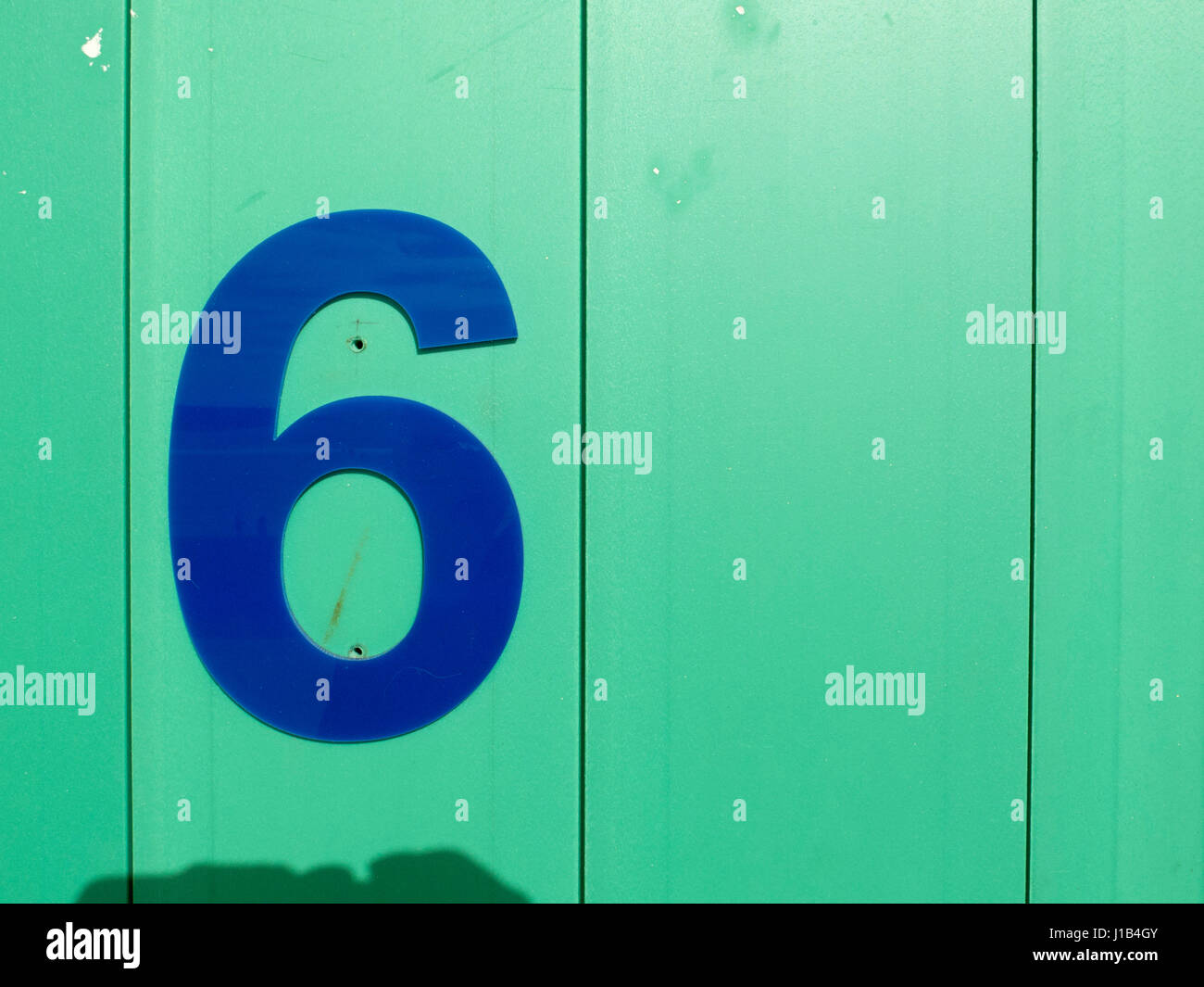 Colourful numbered wooden Beach huts at Barry Island, South Wales ...
