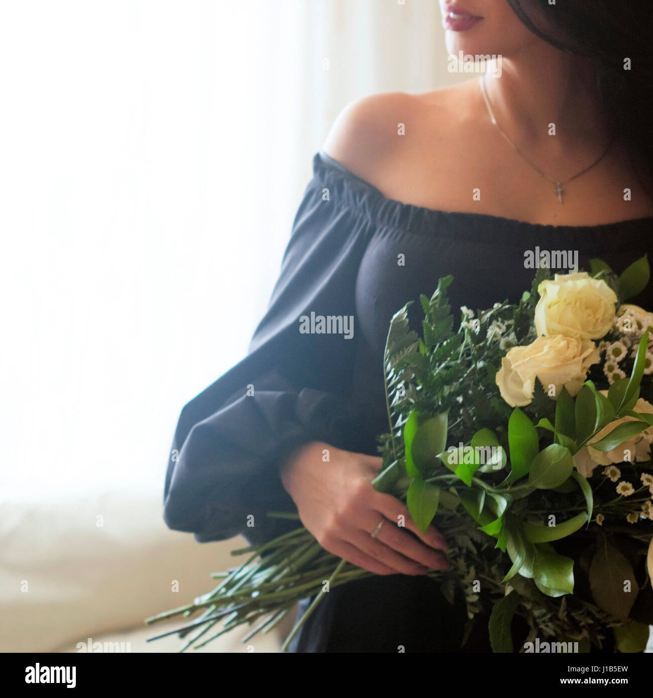 Caucasian woman holding roses Stock Photo - Alamy