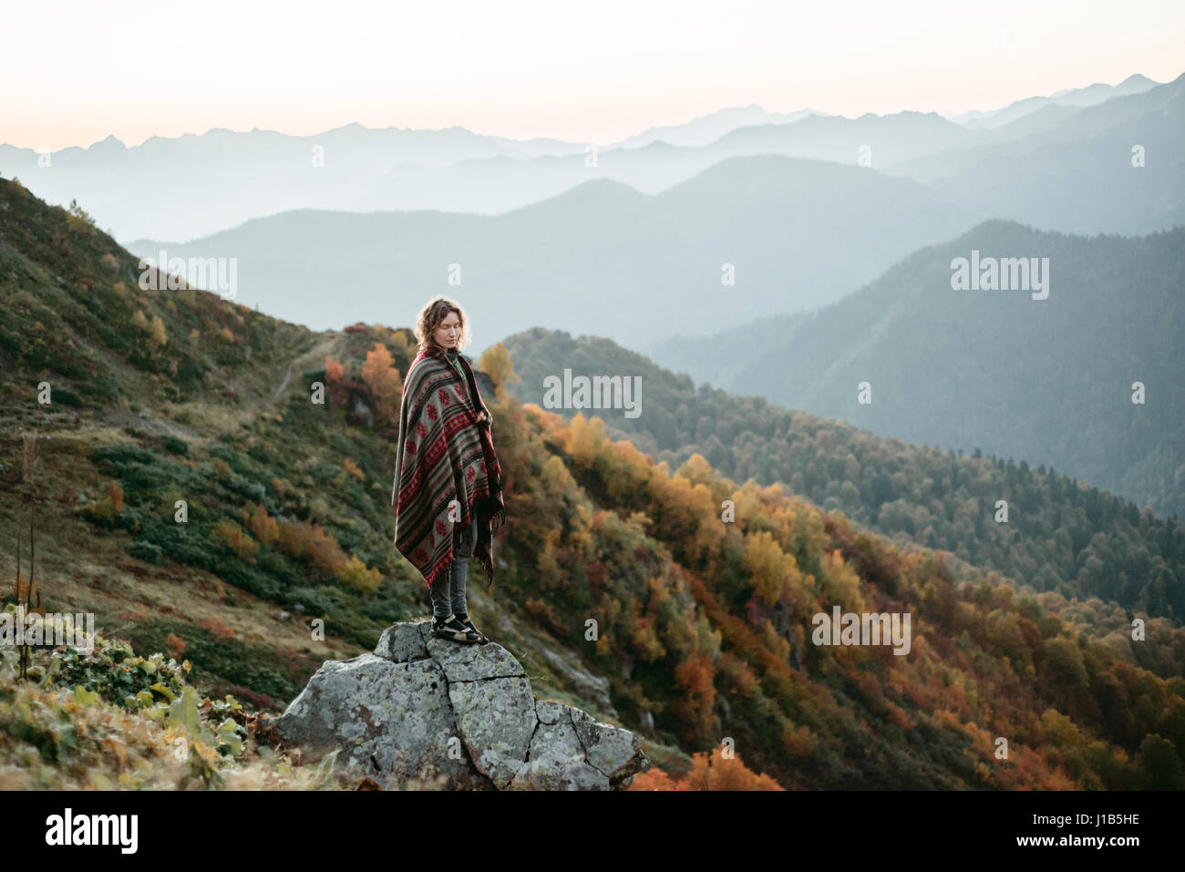 Caucasian woman standing on mountain rock overlooking valley Stock ...