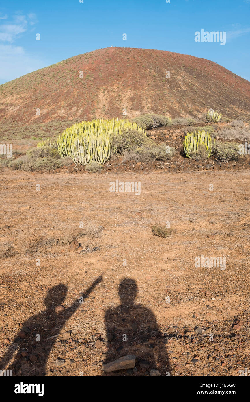 Shadows of people pointing at hill Stock Photo - Alamy