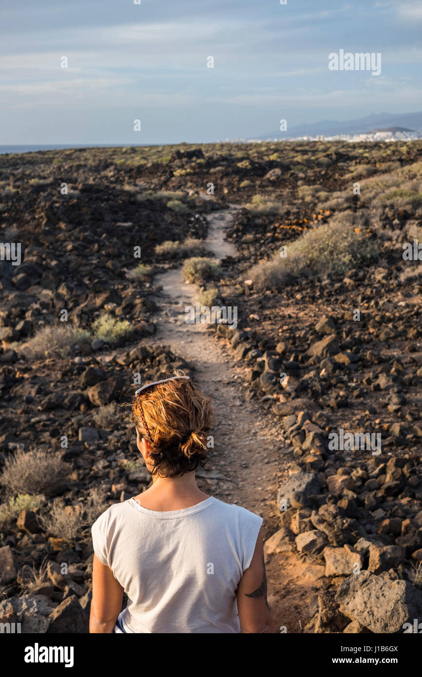 Caucasian woman standing on trail through rocks Stock Photo - Alamy