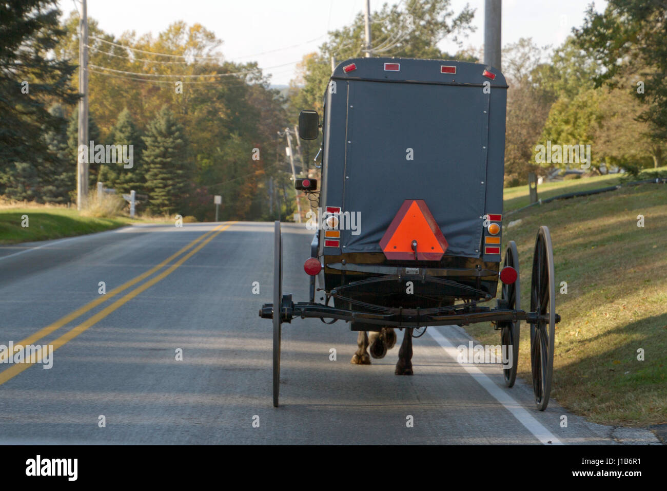 View of the back of an old fashioned, Amish horse-drawn carriage as it ...