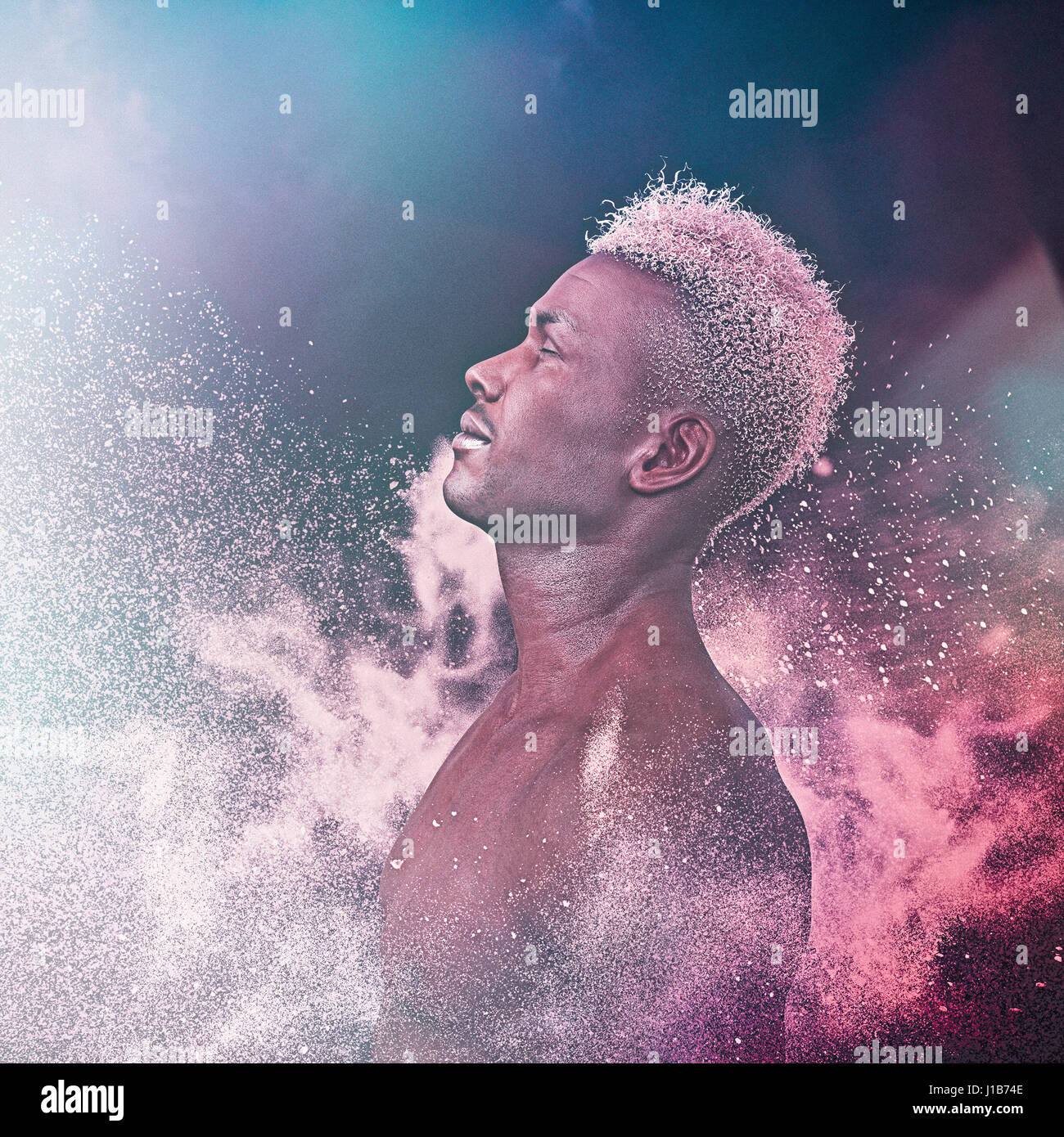 Powder splashing on man with bare chest Stock Photo - Alamy