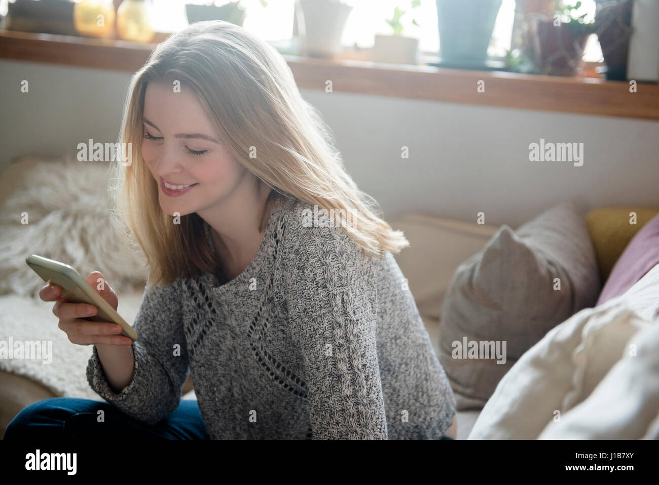 Smiling while texting hi-res stock photography and images - Alamy