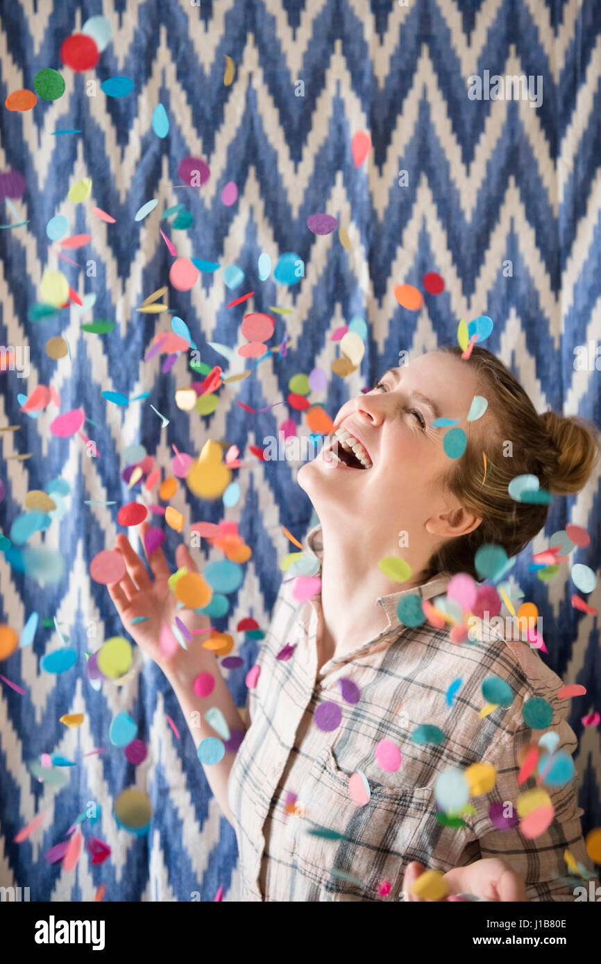 Happy woman celebrating with confetti Stock Photo - Alamy