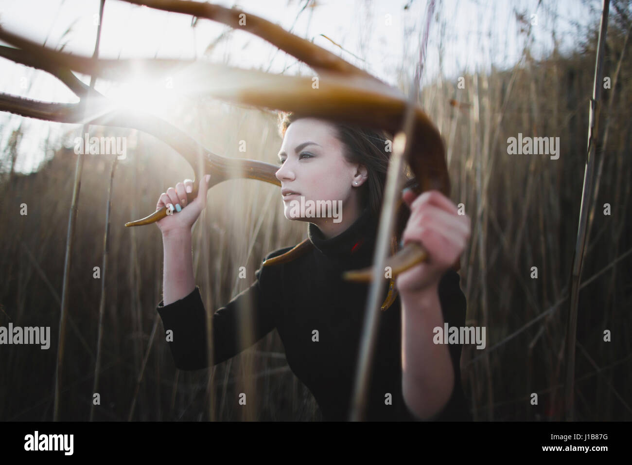 Caucasian woman holding antlers around head Stock Photo - Alamy