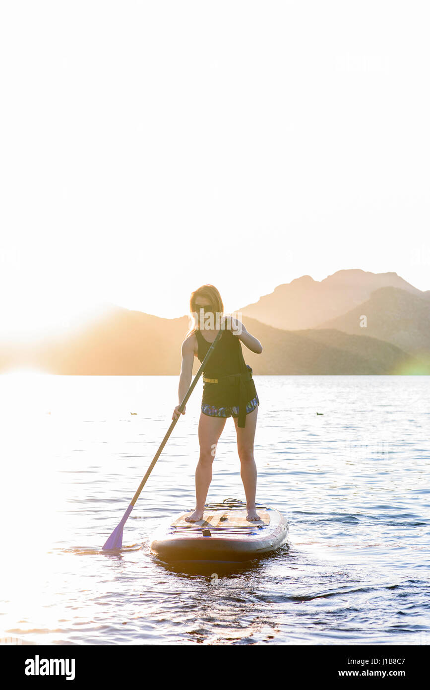 Caucasian woman on paddleboard in river Stock Photo - Alamy