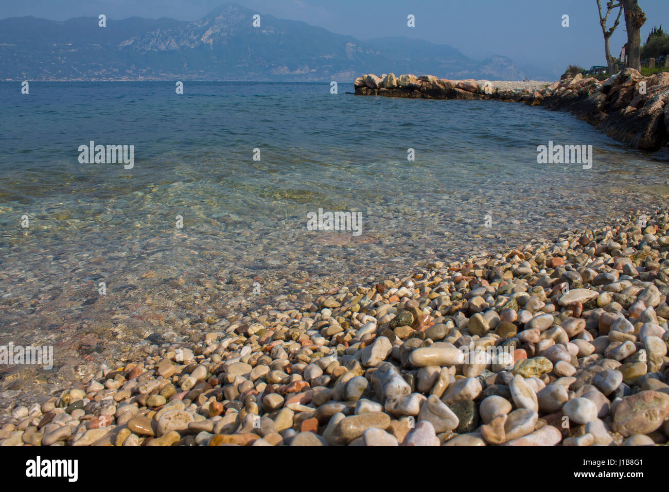 Pebbles in crystal clear lake water close up Stock Photo - Alamy