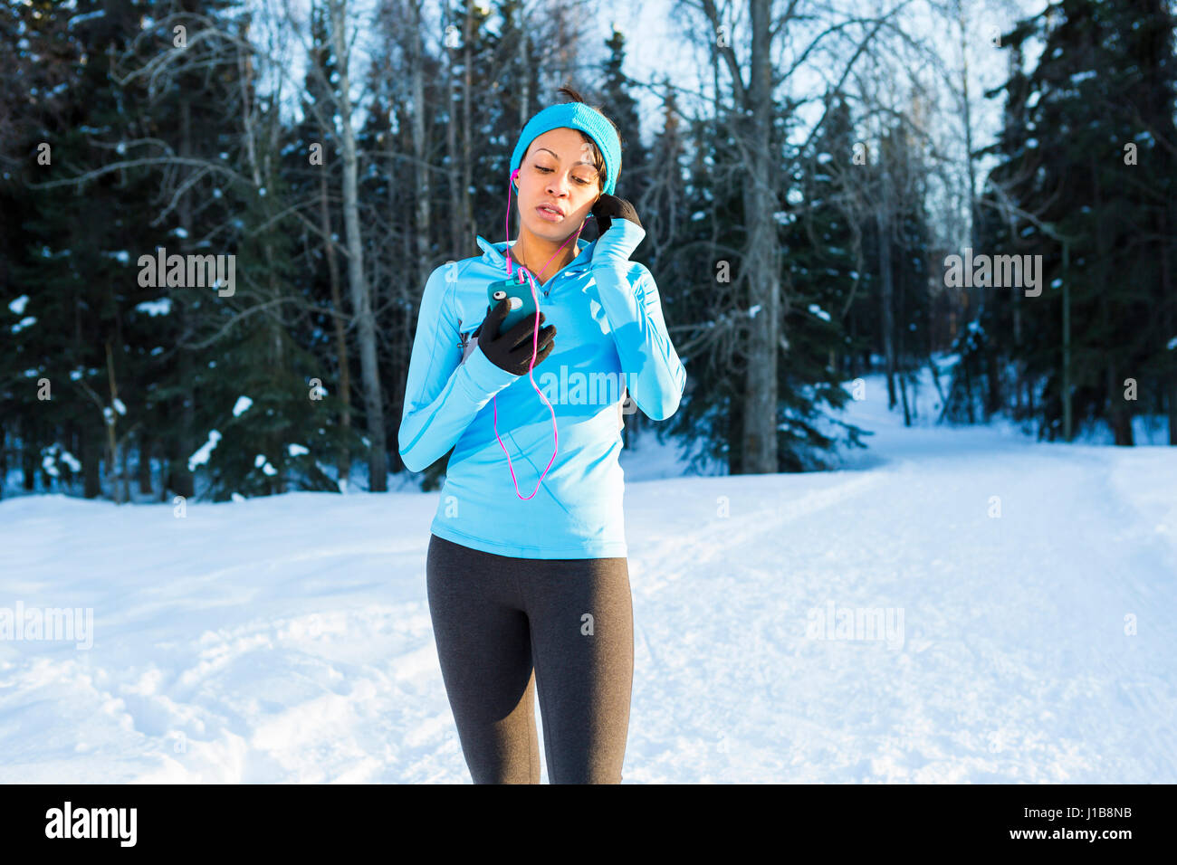 Woman earbuds walking hi-res stock photography and images - Alamy