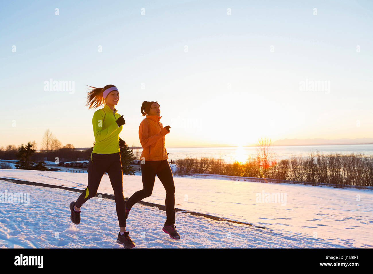 Friend evening dusk winter cold exercise healthy outdoors group hi-res ...