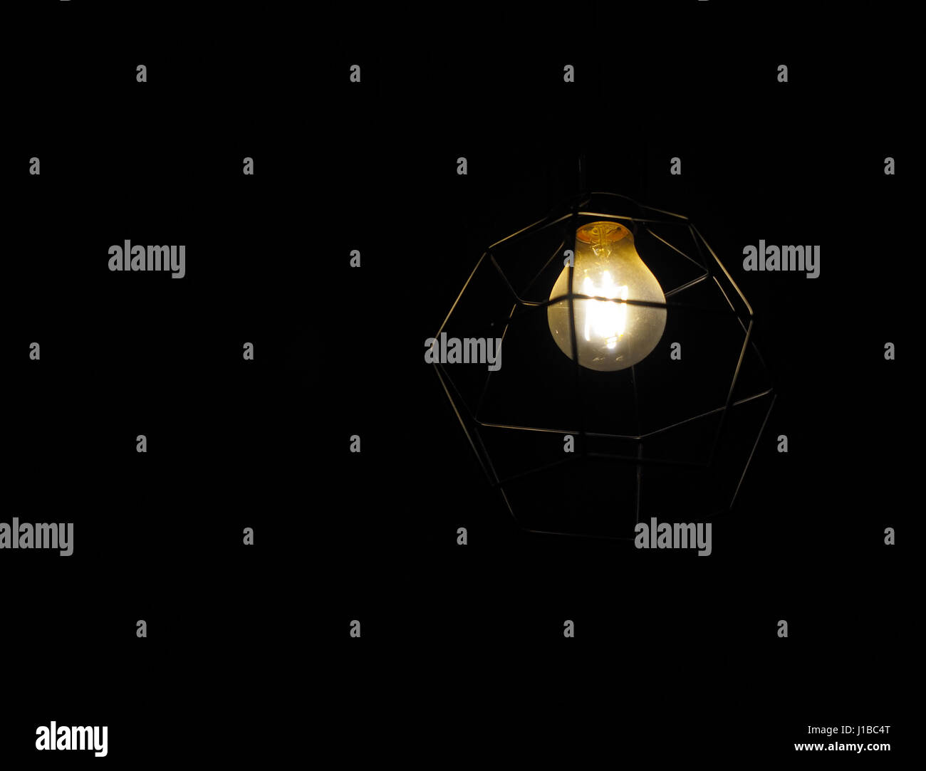 Dim light bulb on dark background Stock Photo - Alamy