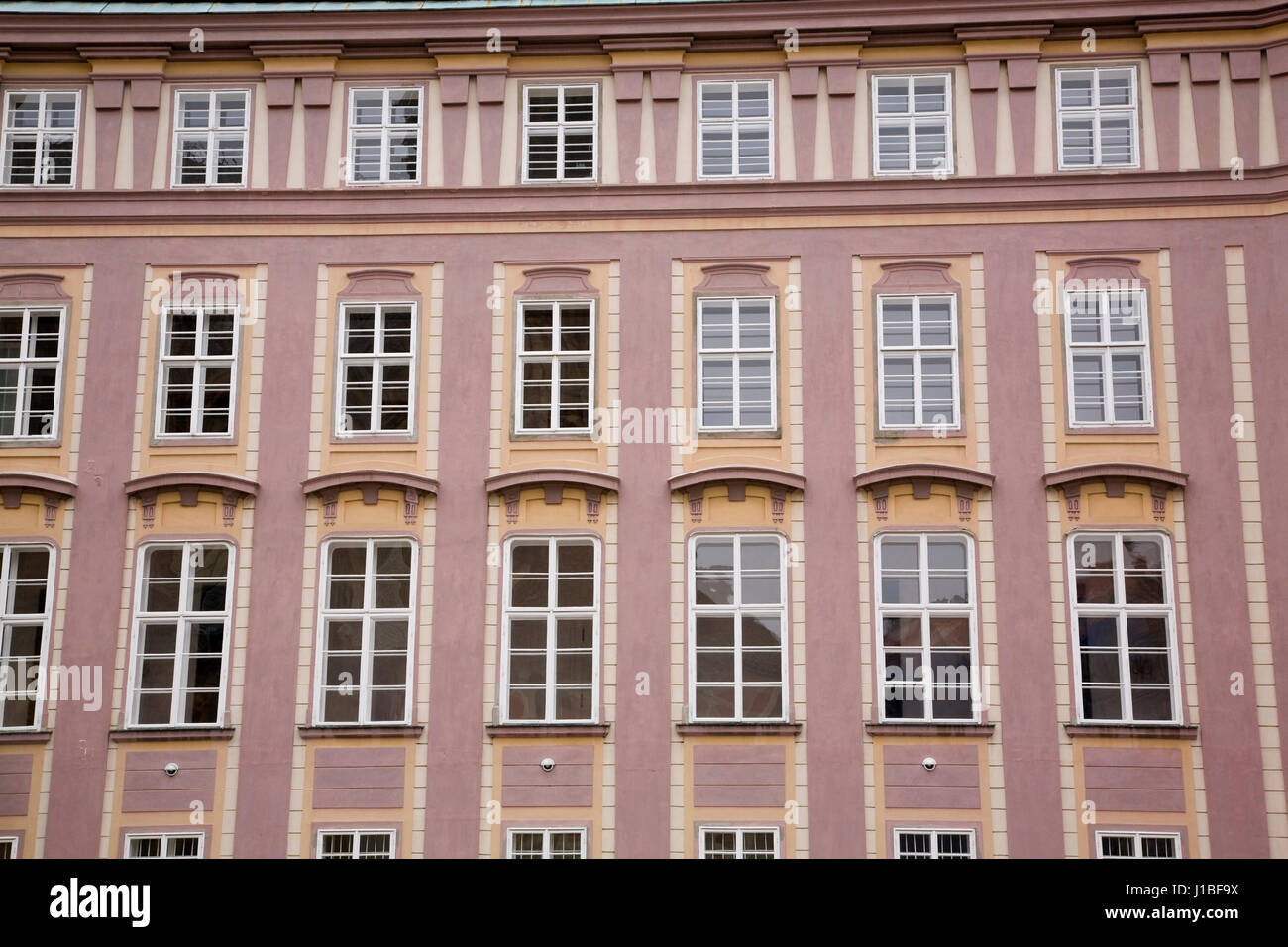 Rows of windows on facade of an old style architectural building in the ...