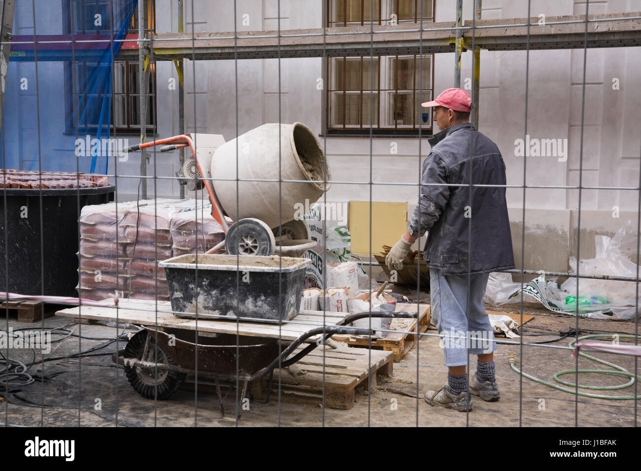 Construction worker mixing cement at a construction site in the Prague ...