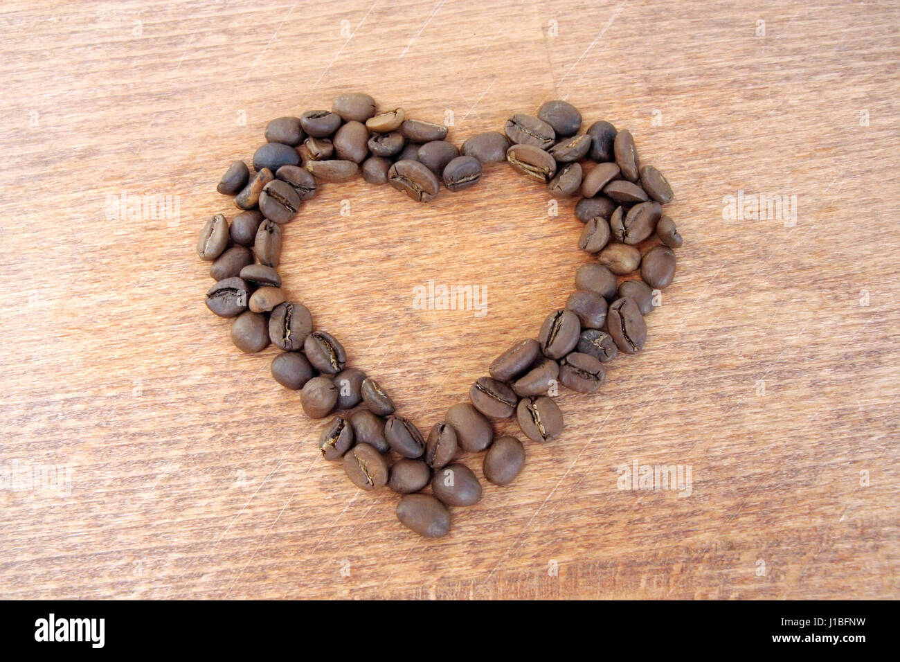 Heart shaped coffee beans. Roasted coffee beans Stock Photo - Alamy