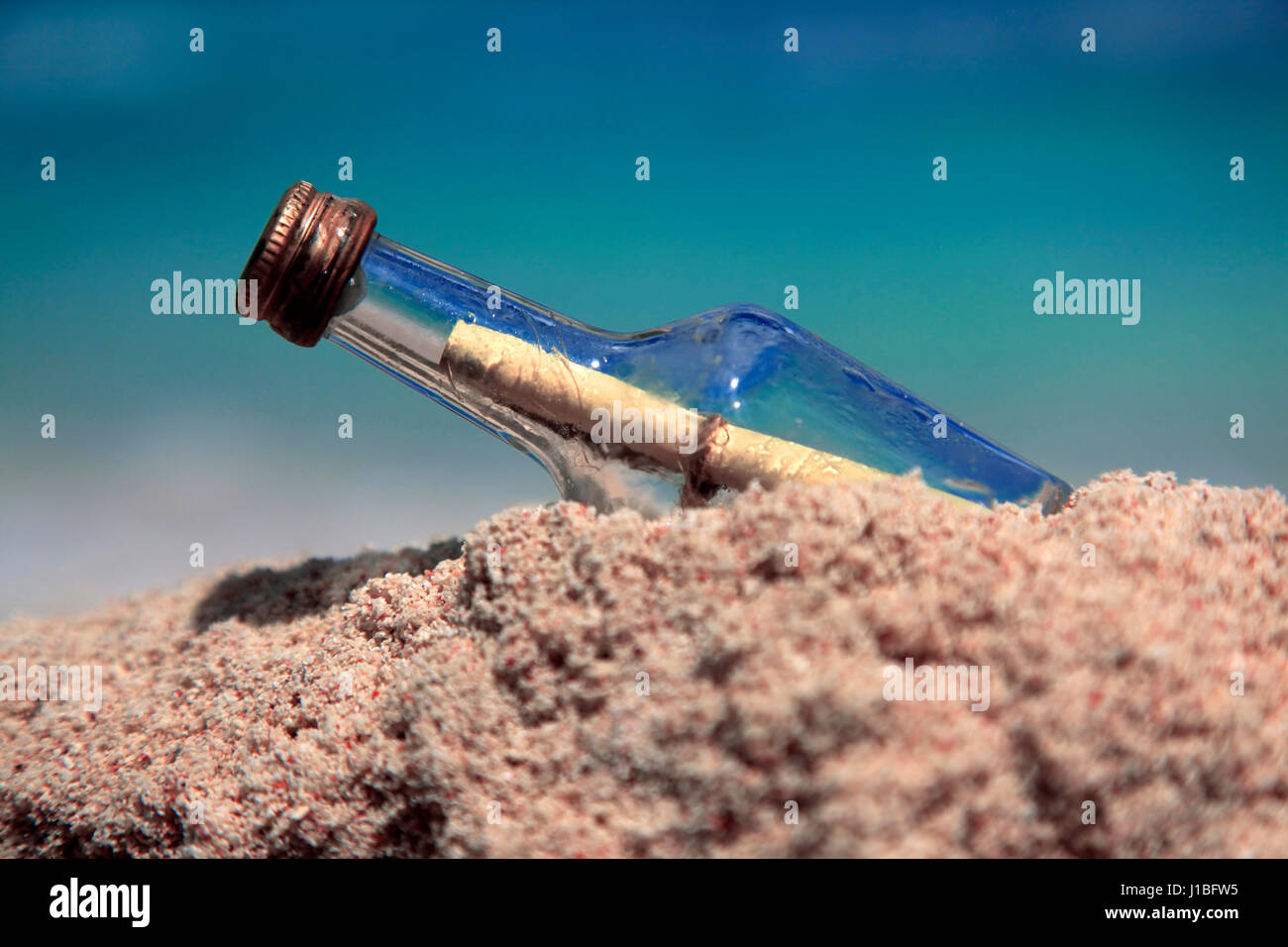 Message in the bottle on sand beach Stock Photo - Alamy