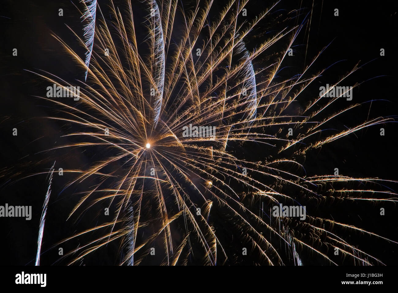 Gold and blue fireworks in the night sky, La Ronde, Montreal, Quebec ...