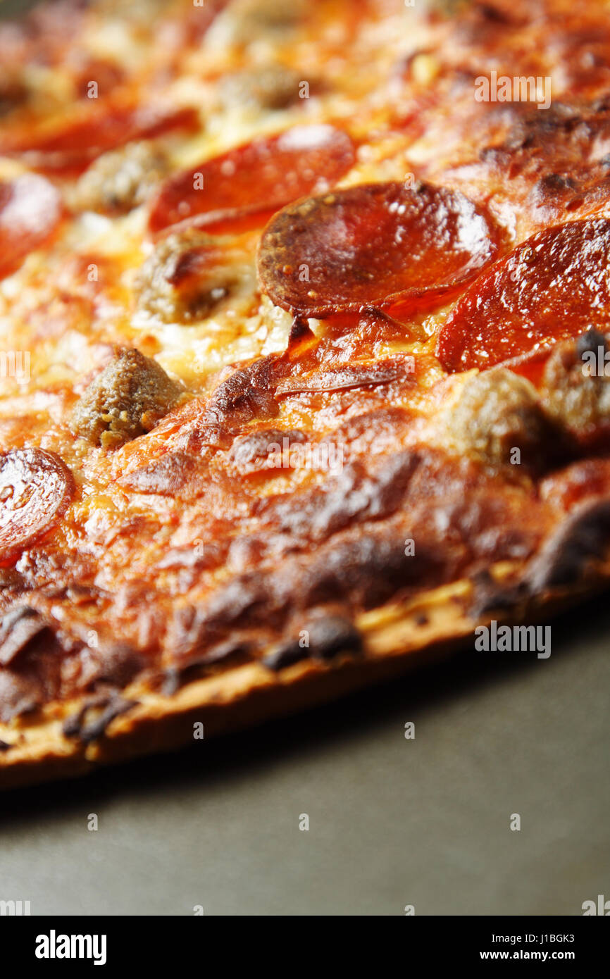 A tasty and delicious thin crust pepperoni pizza Stock Photo - Alamy