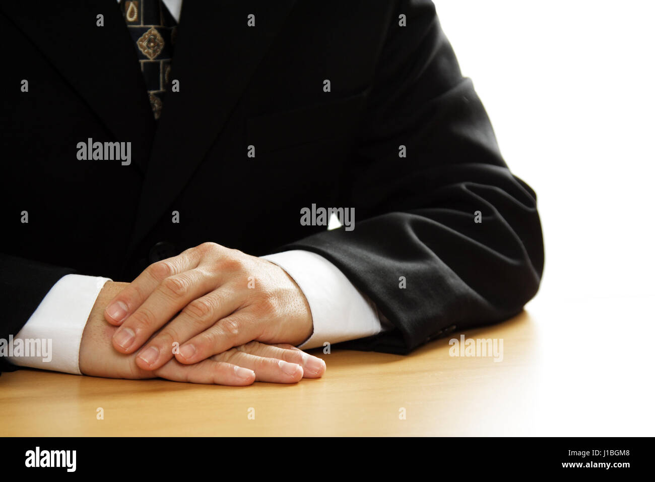 A businessman with his hands on a desk Stock Photo - Alamy