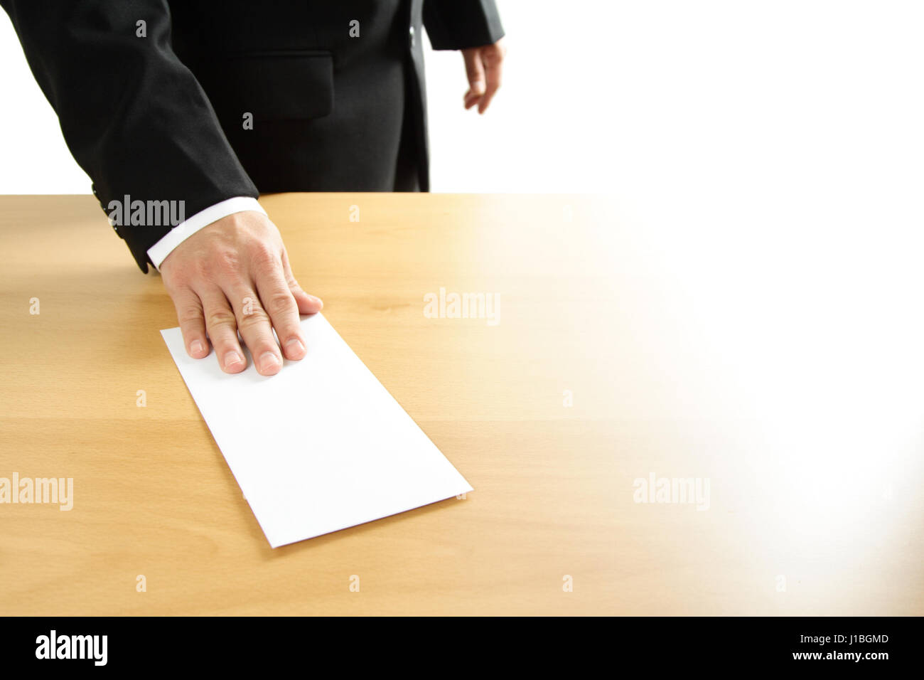 A businessman handing in a blank envelope Stock Photo - Alamy