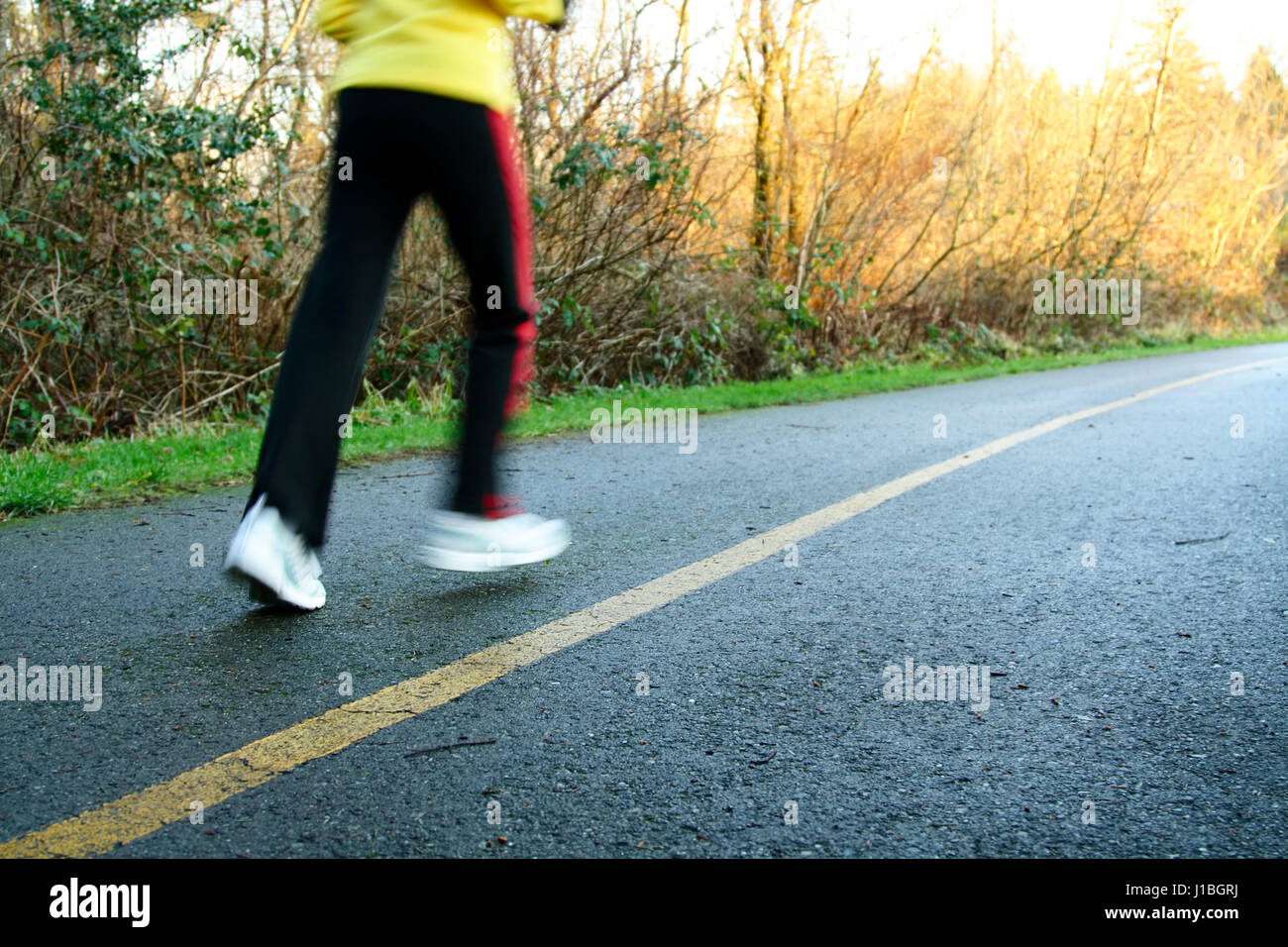 A woman exercising and running in the afternoon Stock Photo - Alamy