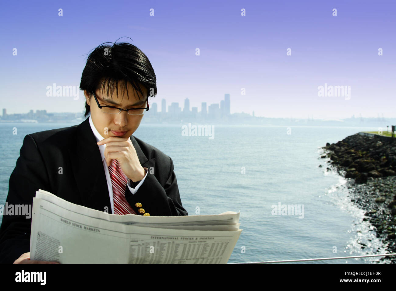 A businessman reading a financial newspaper outdoor Stock Photo - Alamy