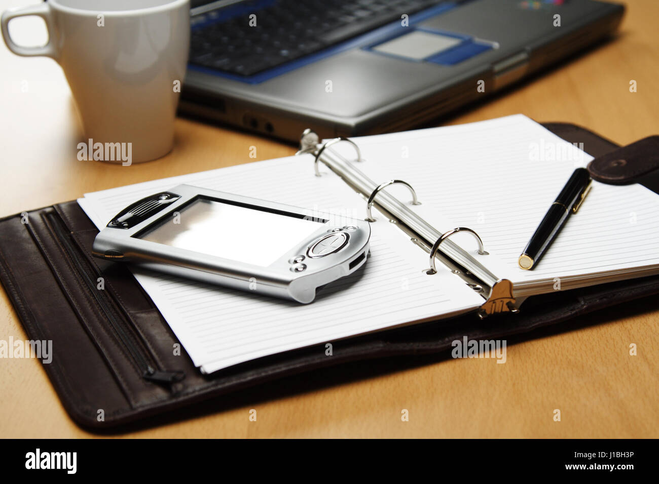 A PDA and a laptop for planning at the office Stock Photo - Alamy